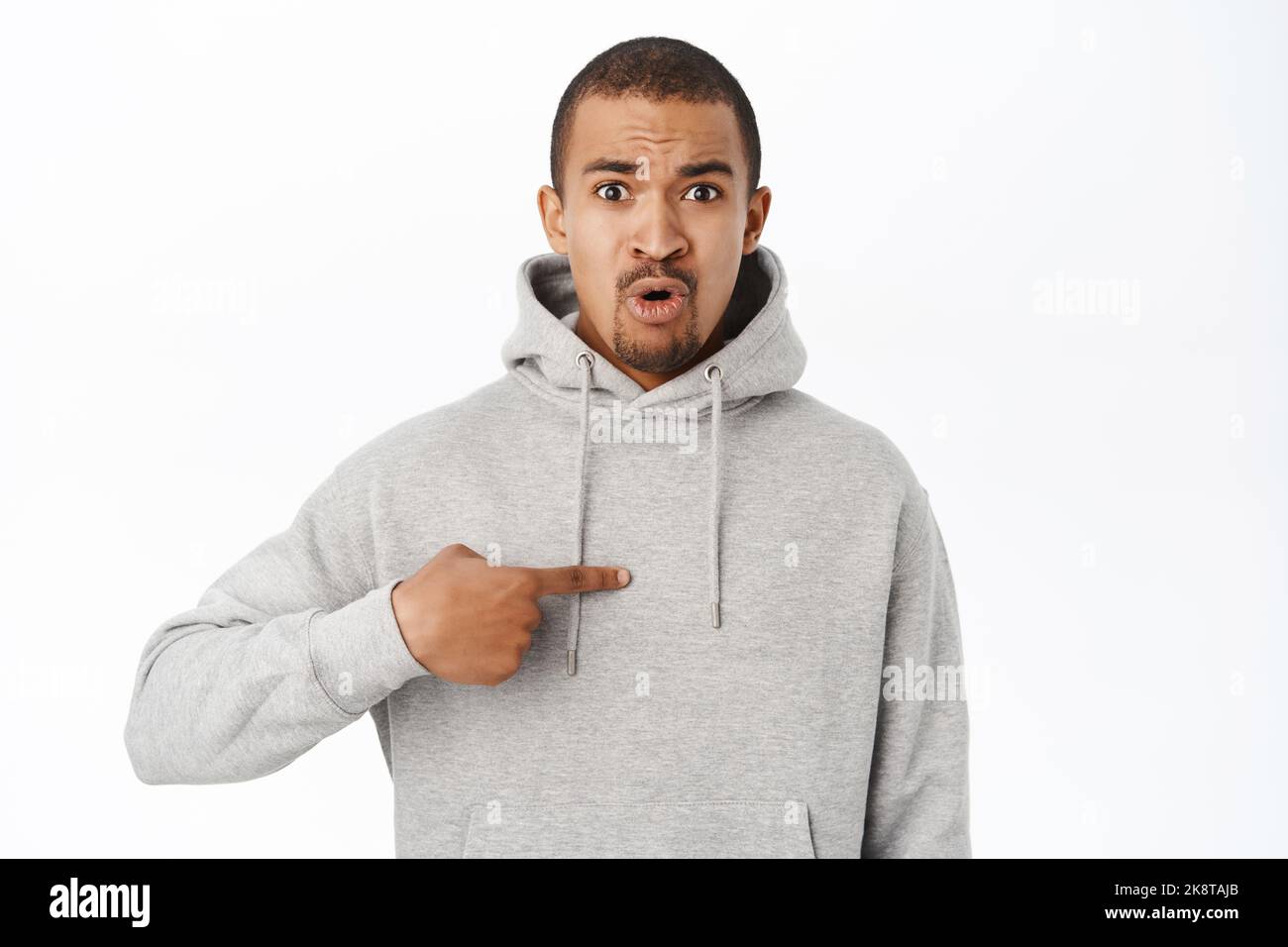 Confused guy points at himself with shocked, concerned face expression ...