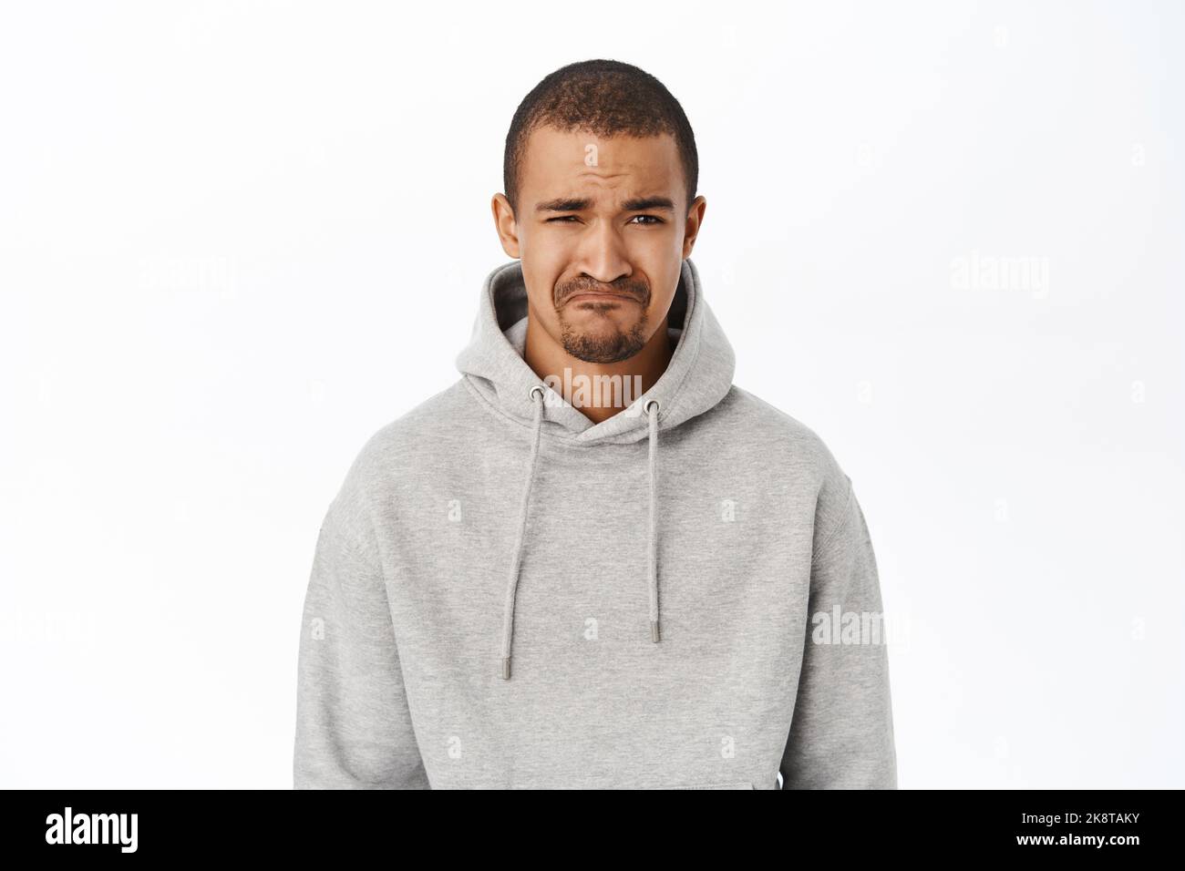 Upset and gloomy man crying, sulking with disappointed face, standing ...