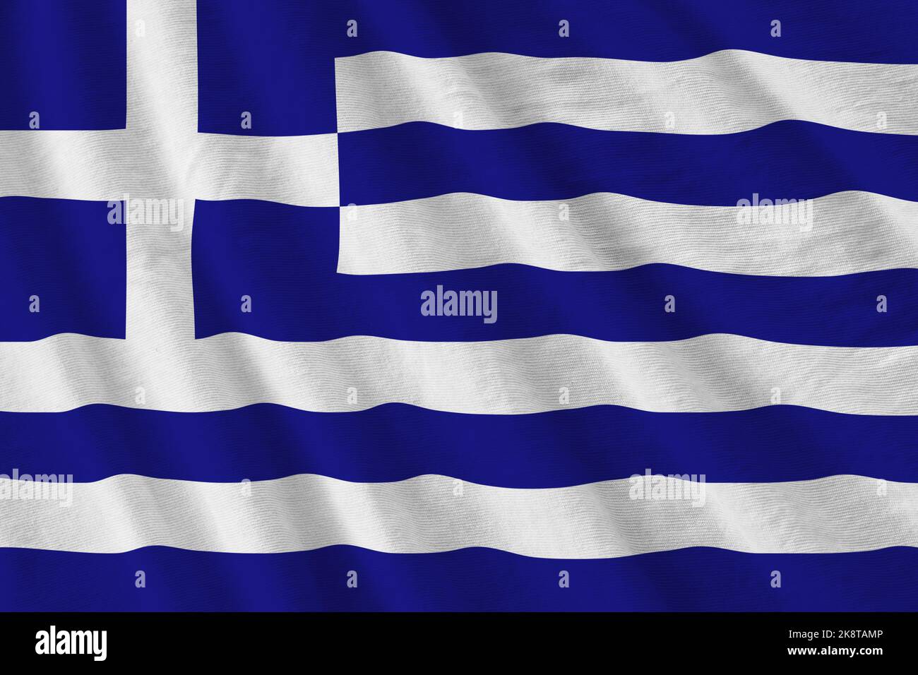 Greece flag with big folds waving close up under the studio light ...
