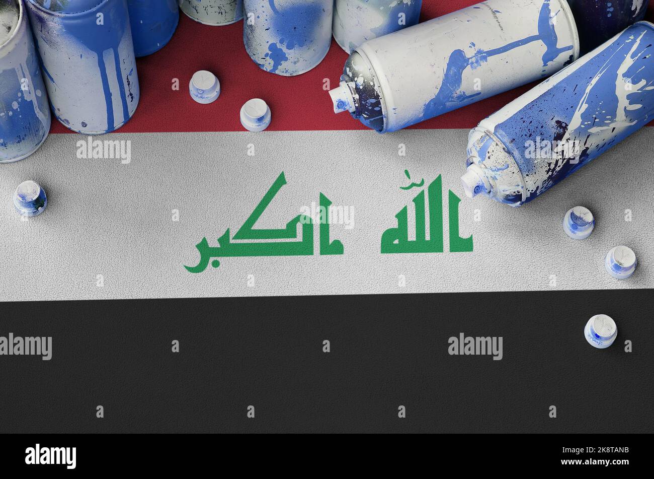 Iraq flag and few used aerosol spray cans for graffiti painting. Street ...