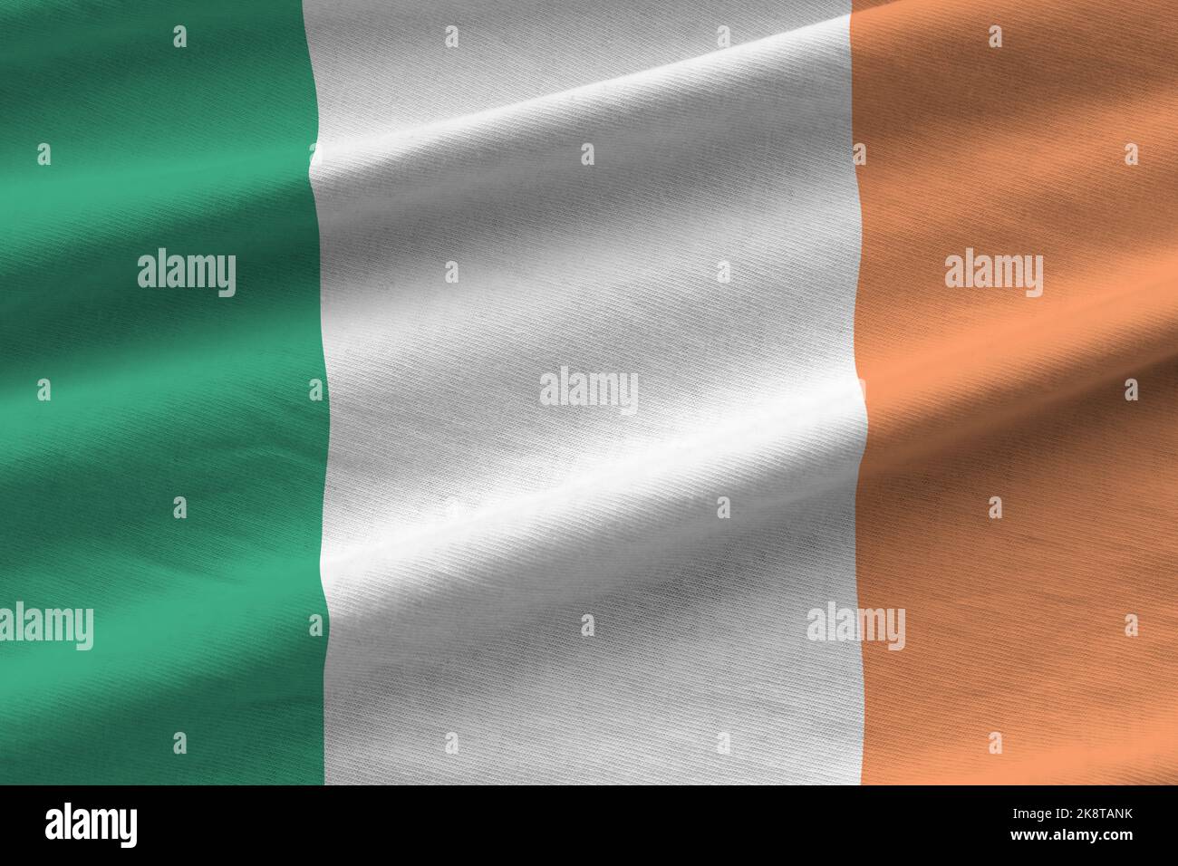 Ireland flag with big folds waving close up under the studio light ...
