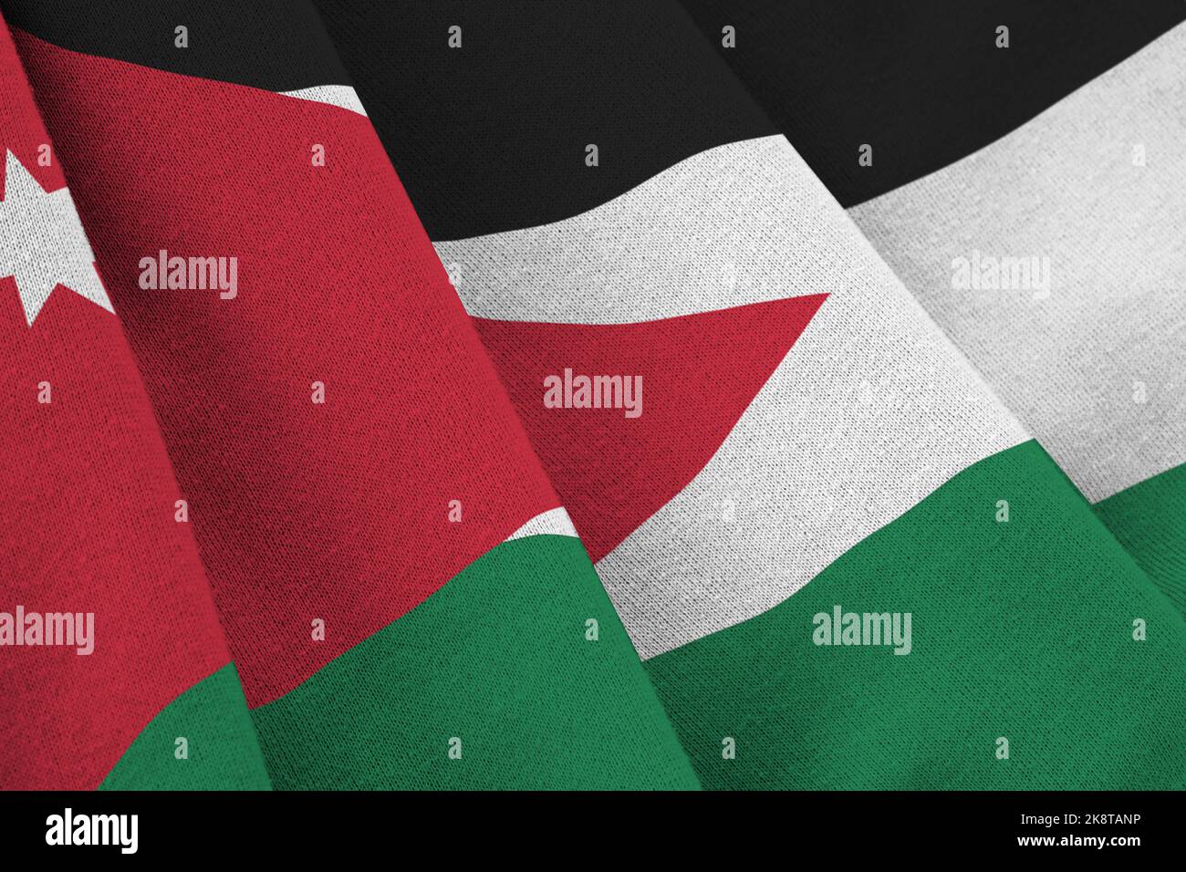 Jordan flag with big folds waving close up under the studio light ...