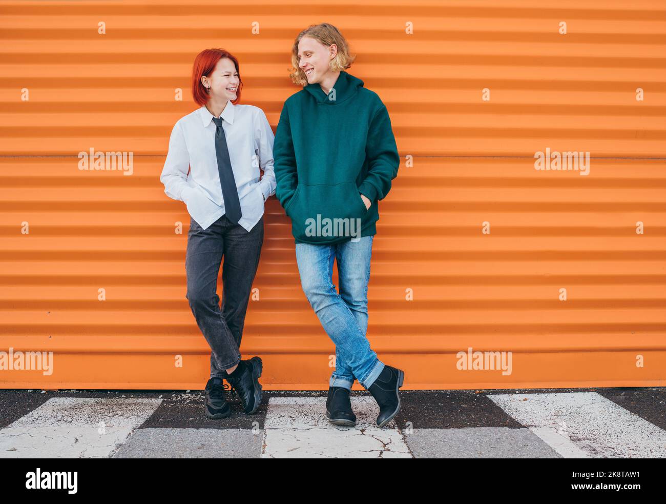 Portraits of two smiling to each other caucasian teen friends boy and ...