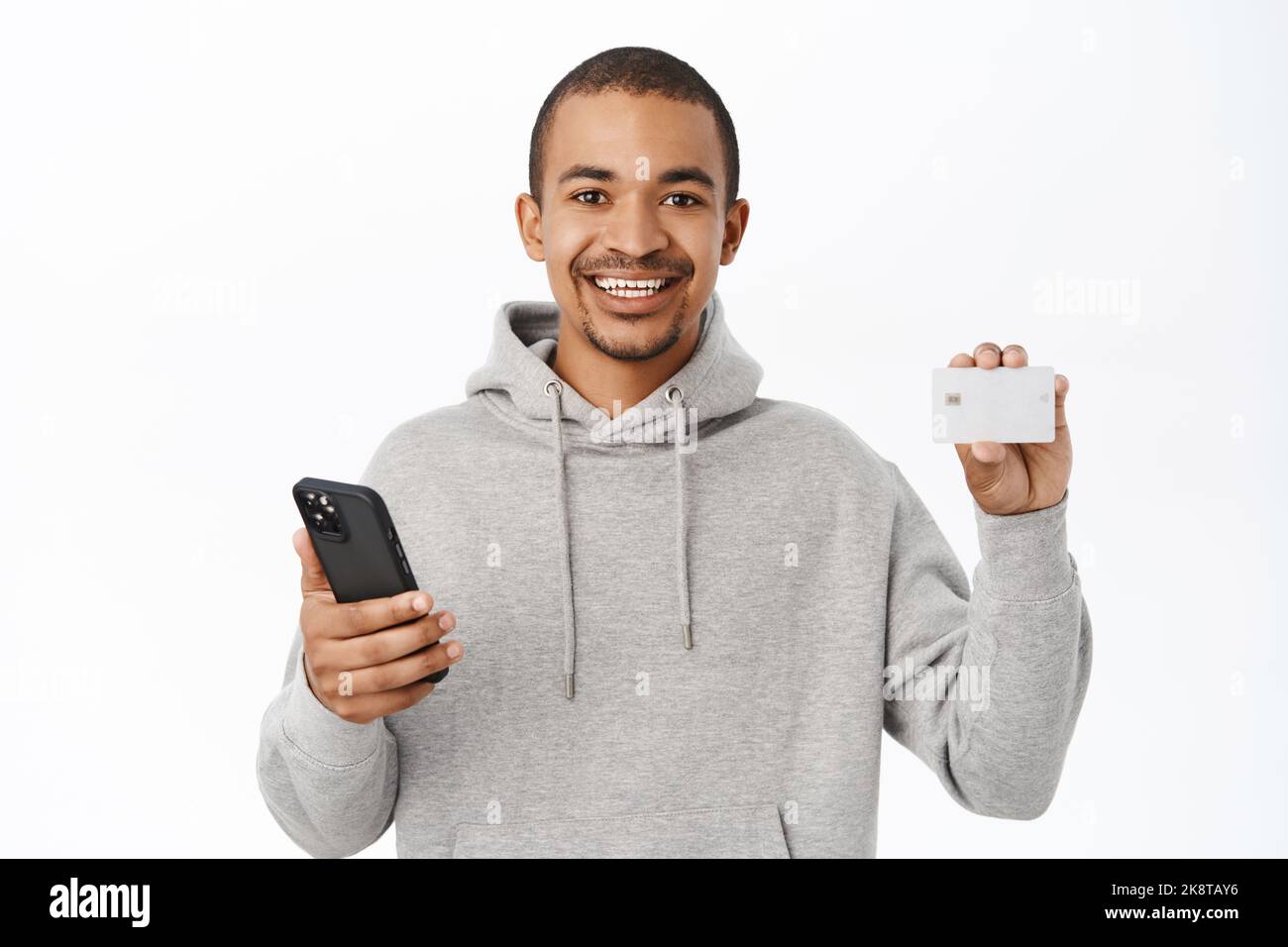 Online banking, money transfer. Excited guy shows credit card and ...