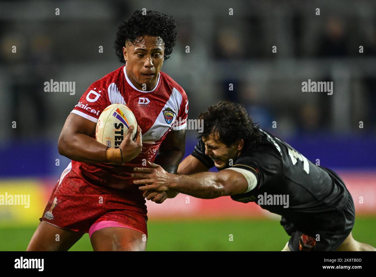 Tesi Niu of Tonga evades the tackle of Bailey Antrobus of Wales during ...