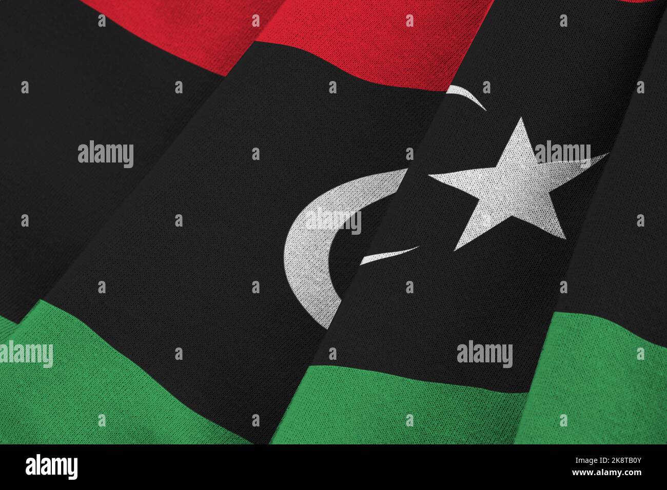Libya flag with big folds waving close up under the studio light ...