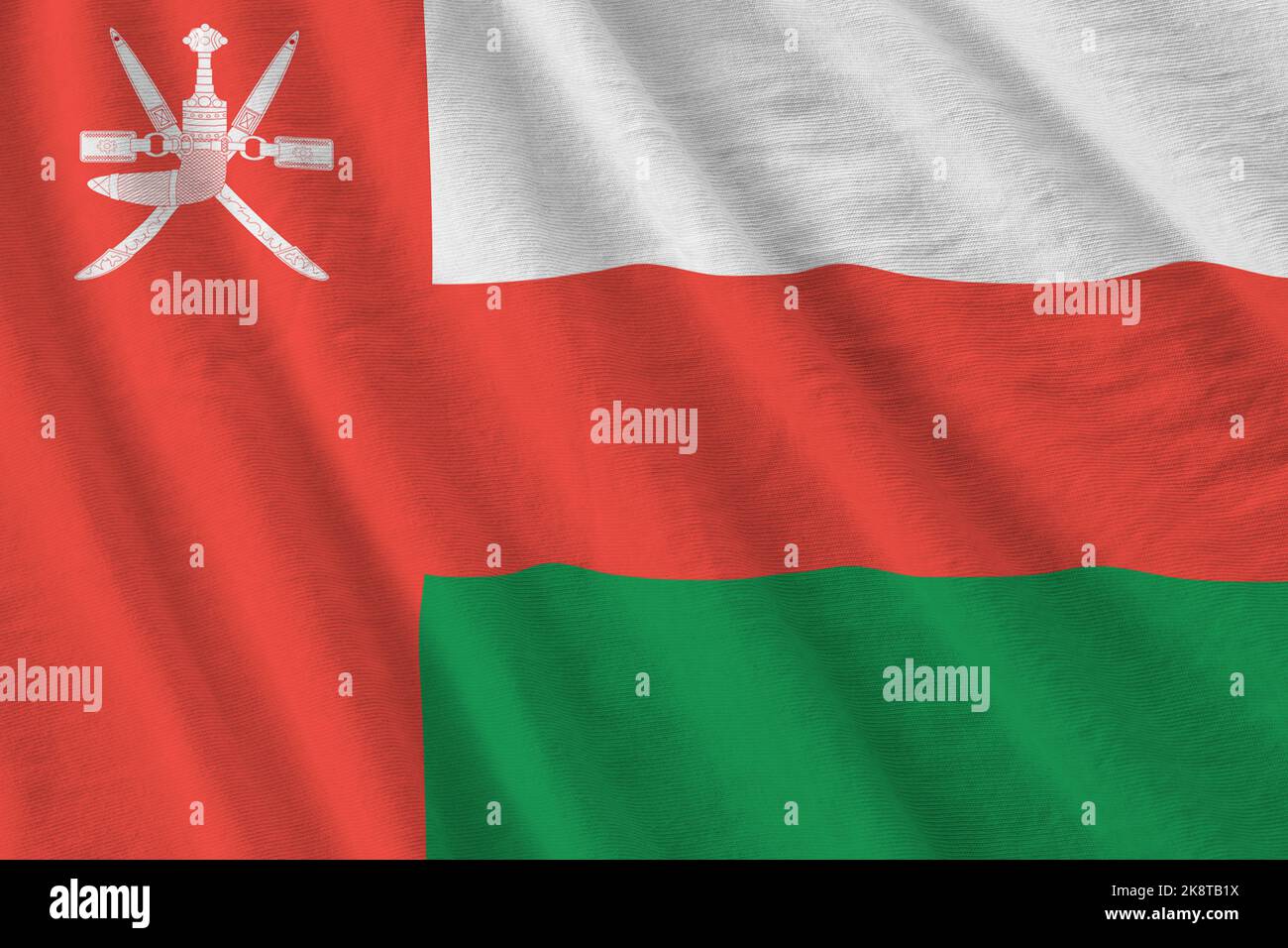 Oman flag with big folds waving close up under the studio light indoors ...