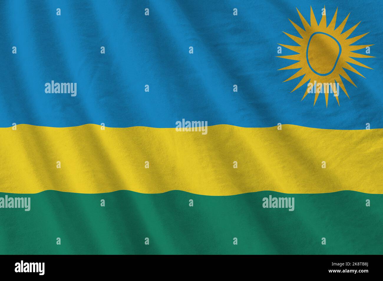 Rwanda flag with big folds waving close up under the studio light ...