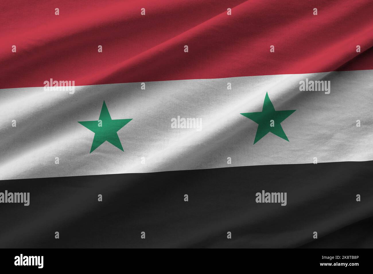 Syria flag with big folds waving close up under the studio light ...