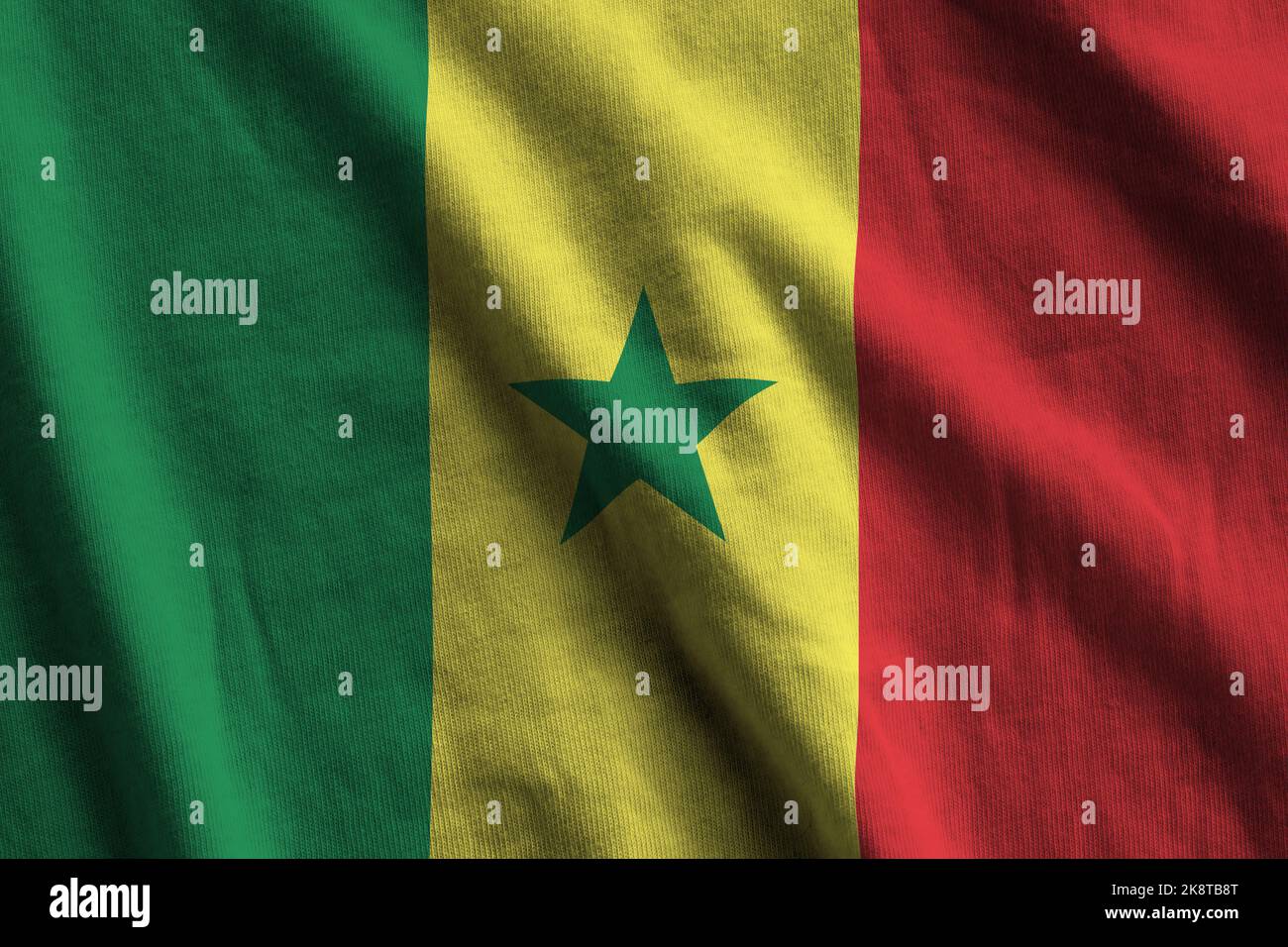 Senegal flag with big folds waving close up under the studio light ...