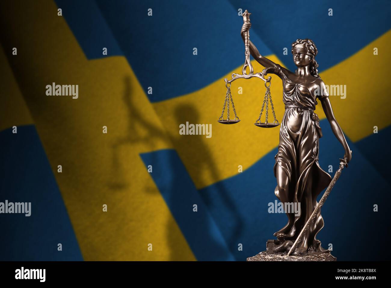 Sweden flag with statue of lady justice and judicial scales in dark ...