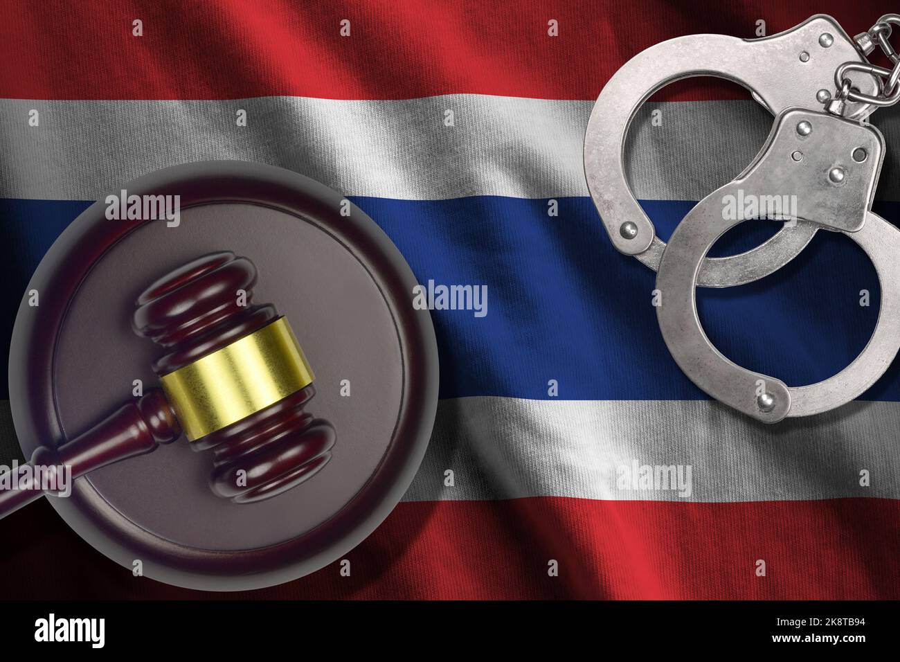 Thailand flag with judge mallet and handcuffs in dark room. Concept of ...