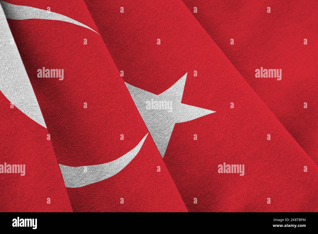 Turkey flag with big folds waving close up under the studio light ...