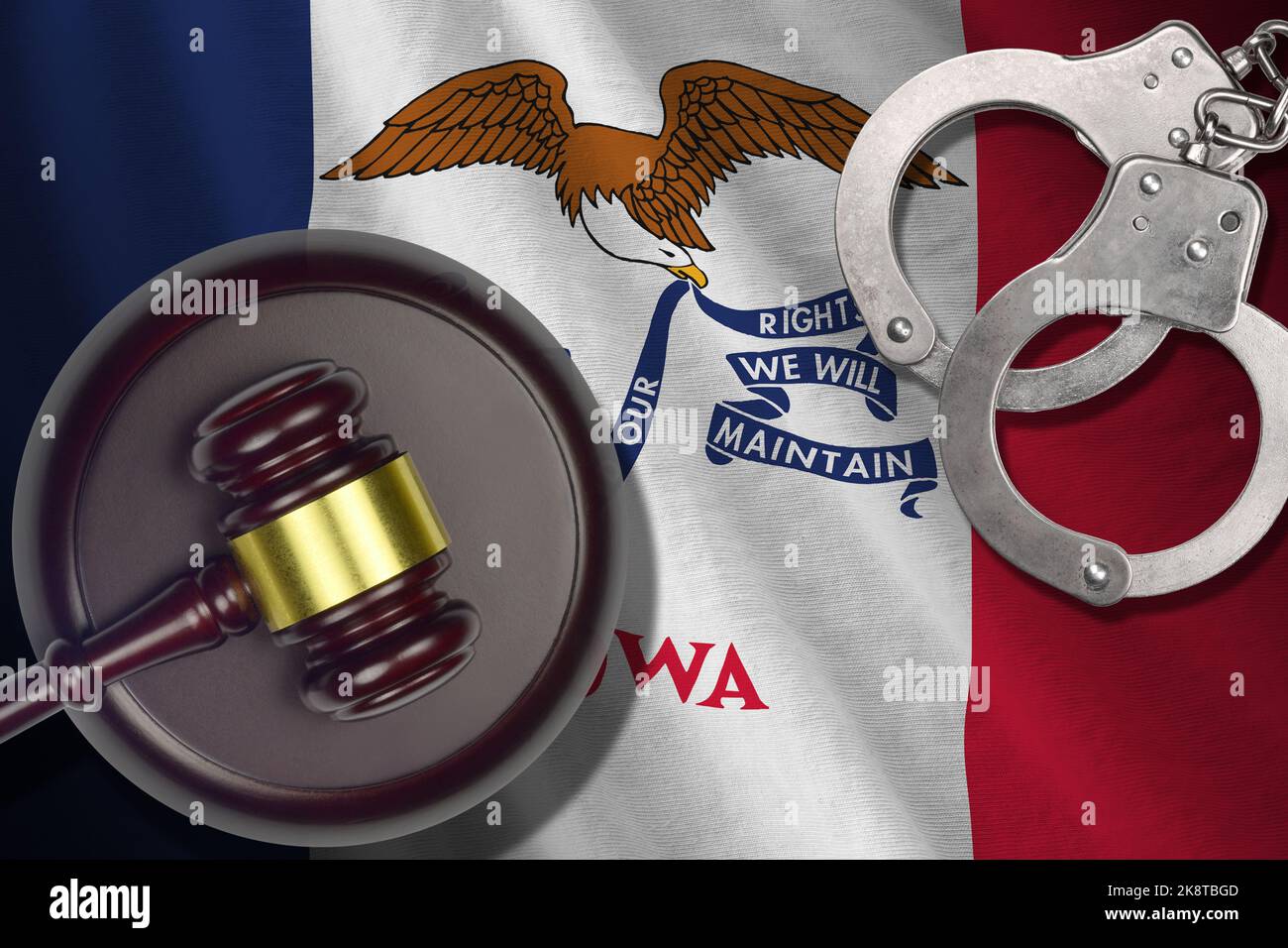 Iowa US state flag with judge mallet and handcuffs in dark room ...