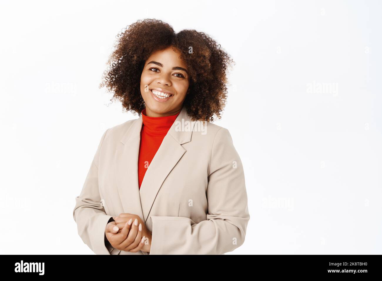 Smiling african american businesswoman in suit, looking friendly at ...