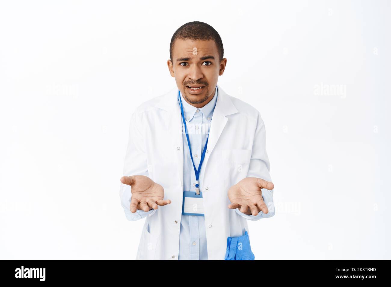 Doctor looking confused and worried, pointing at camera, showing empty ...