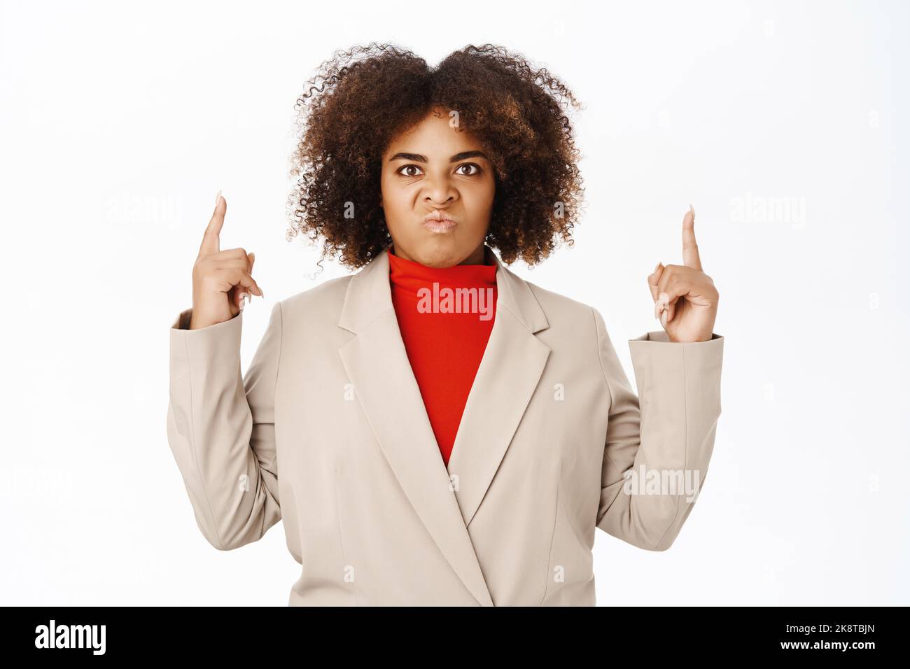 Annoyed and angry african american businesswoman, pointing fingers up ...
