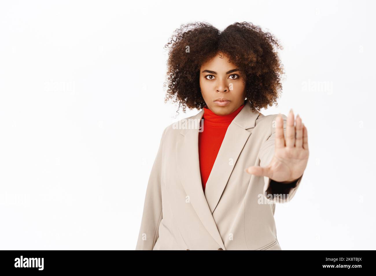 Stop right there. Serious african american businesswoman extends one ...