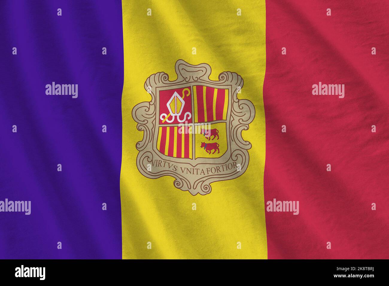 Andorra flag with big folds waving close up under the studio light ...
