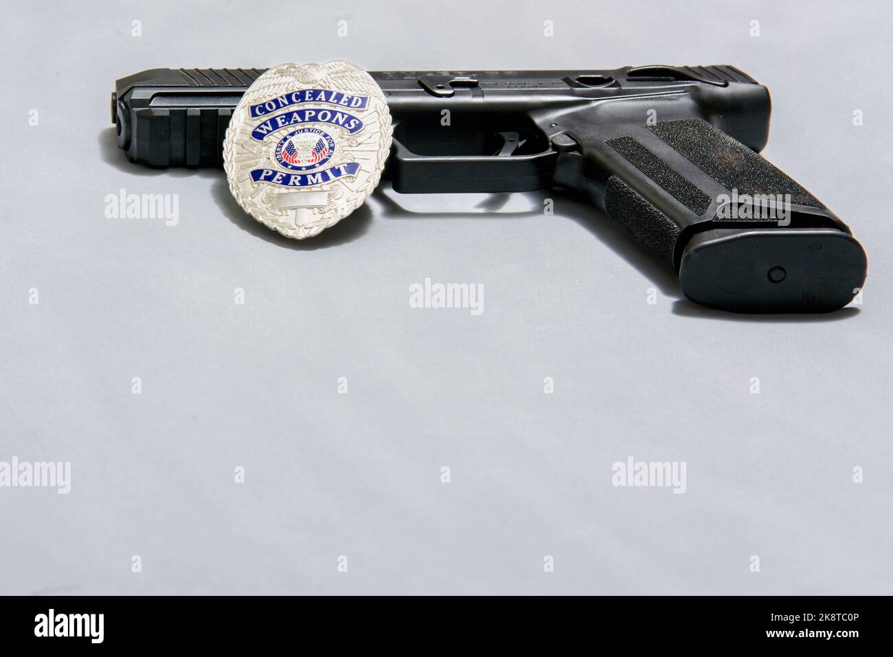 Gun and Badge on white background Stock Photo - Alamy