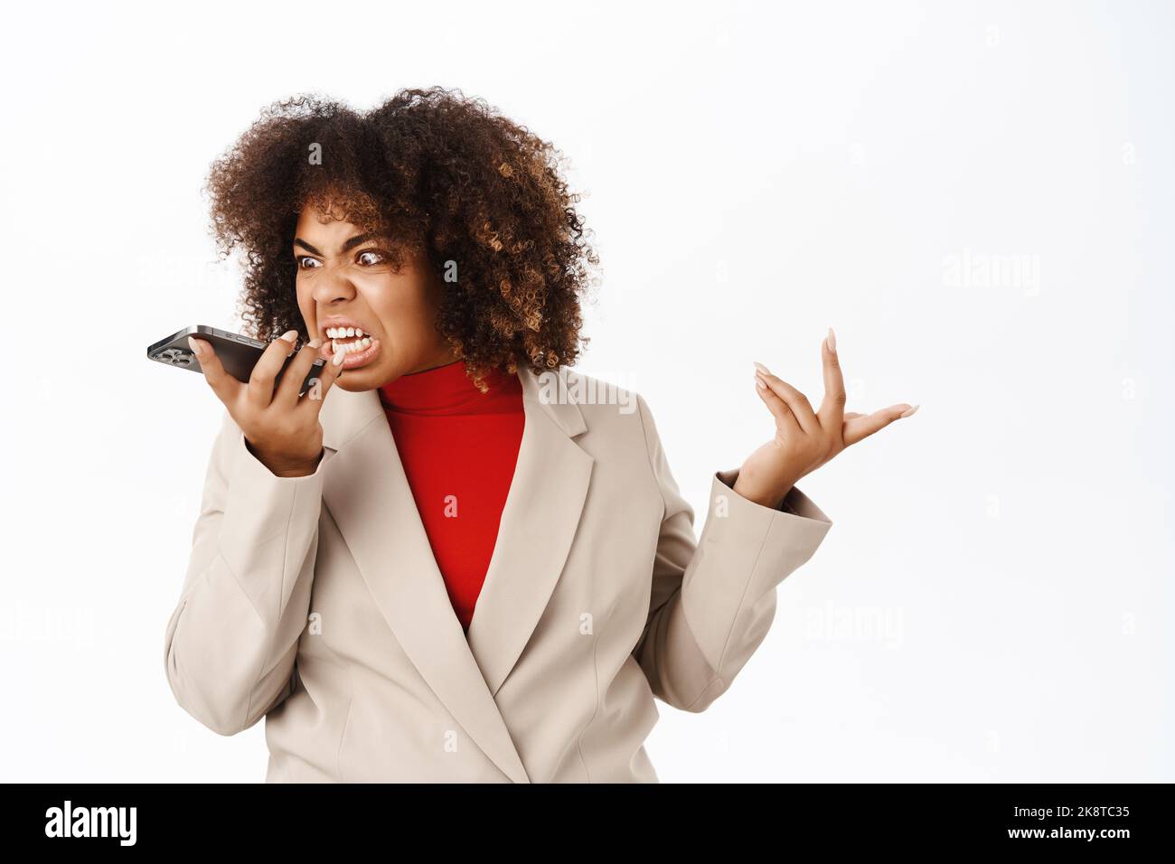Angry businesswoman arguing on call, screaming at mobile phone ...