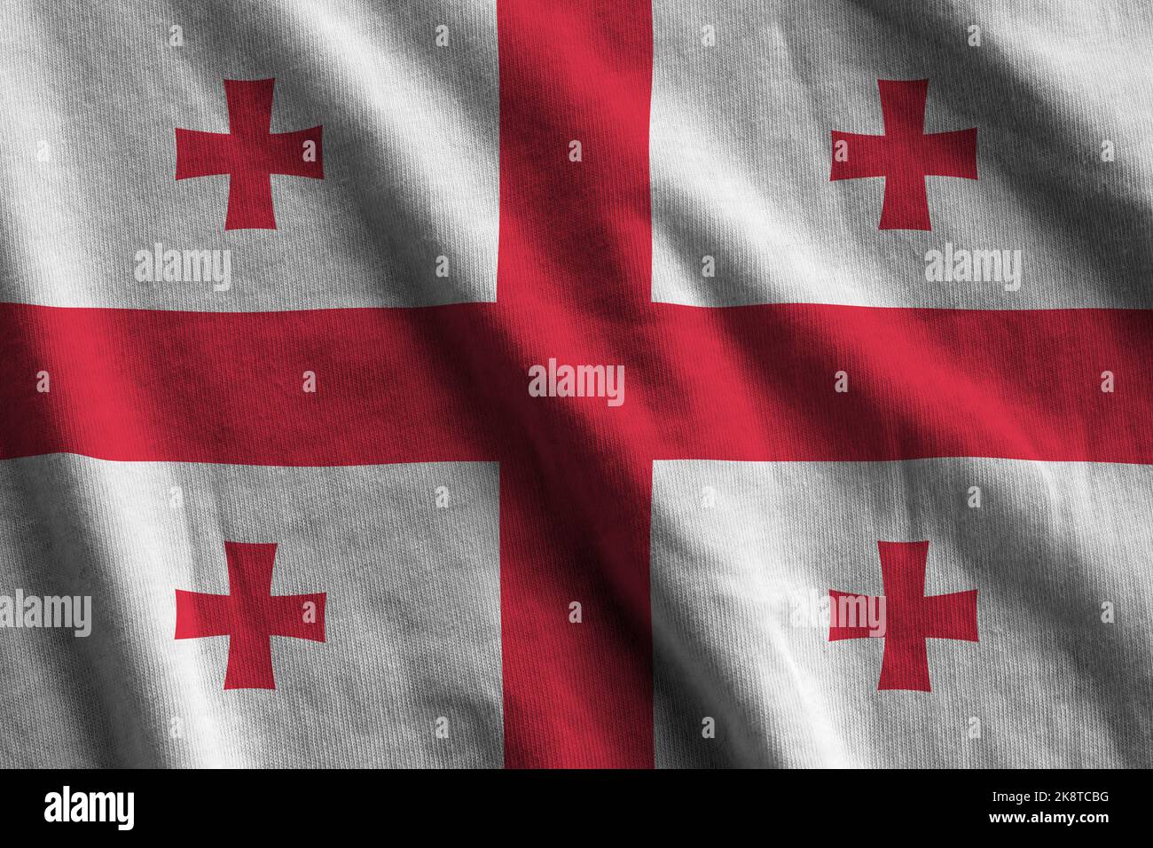 Georgia flag with big folds waving close up under the studio light ...