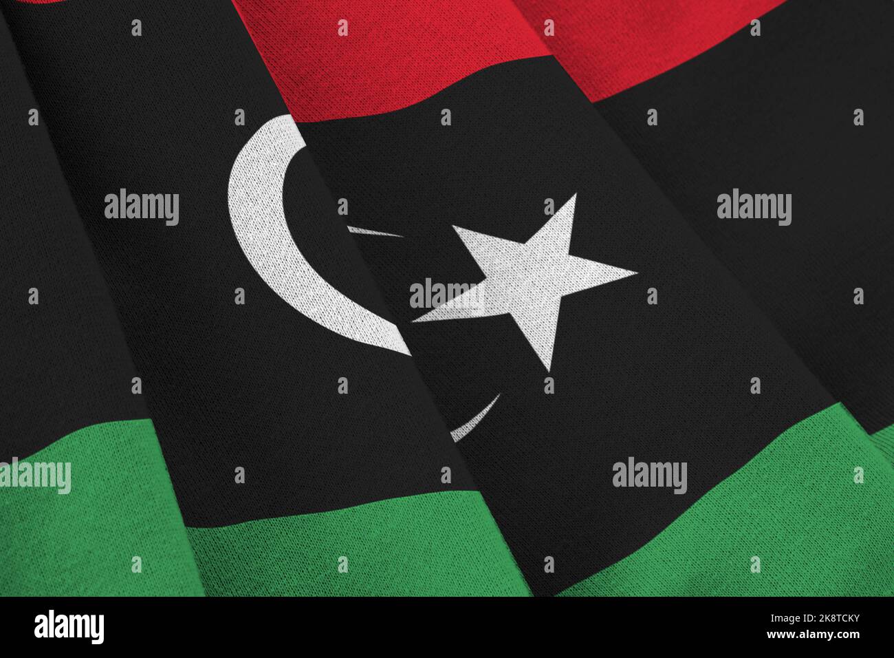 Libya flag with big folds waving close up under the studio light ...