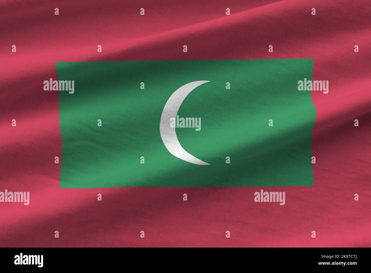 Maldives flag with big folds waving close up under the studio light ...