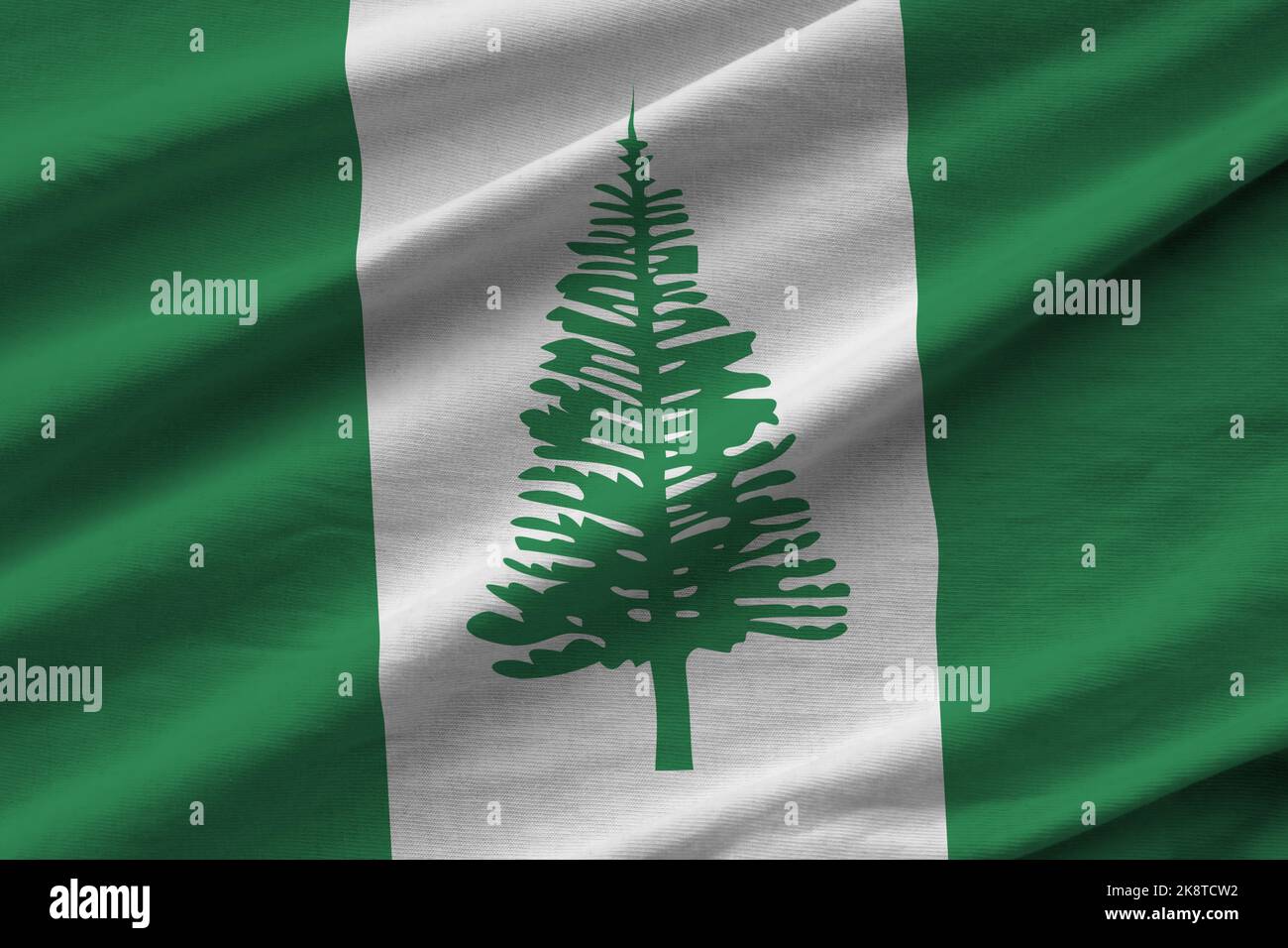 Norfolk island flag with big folds waving close up under the studio ...