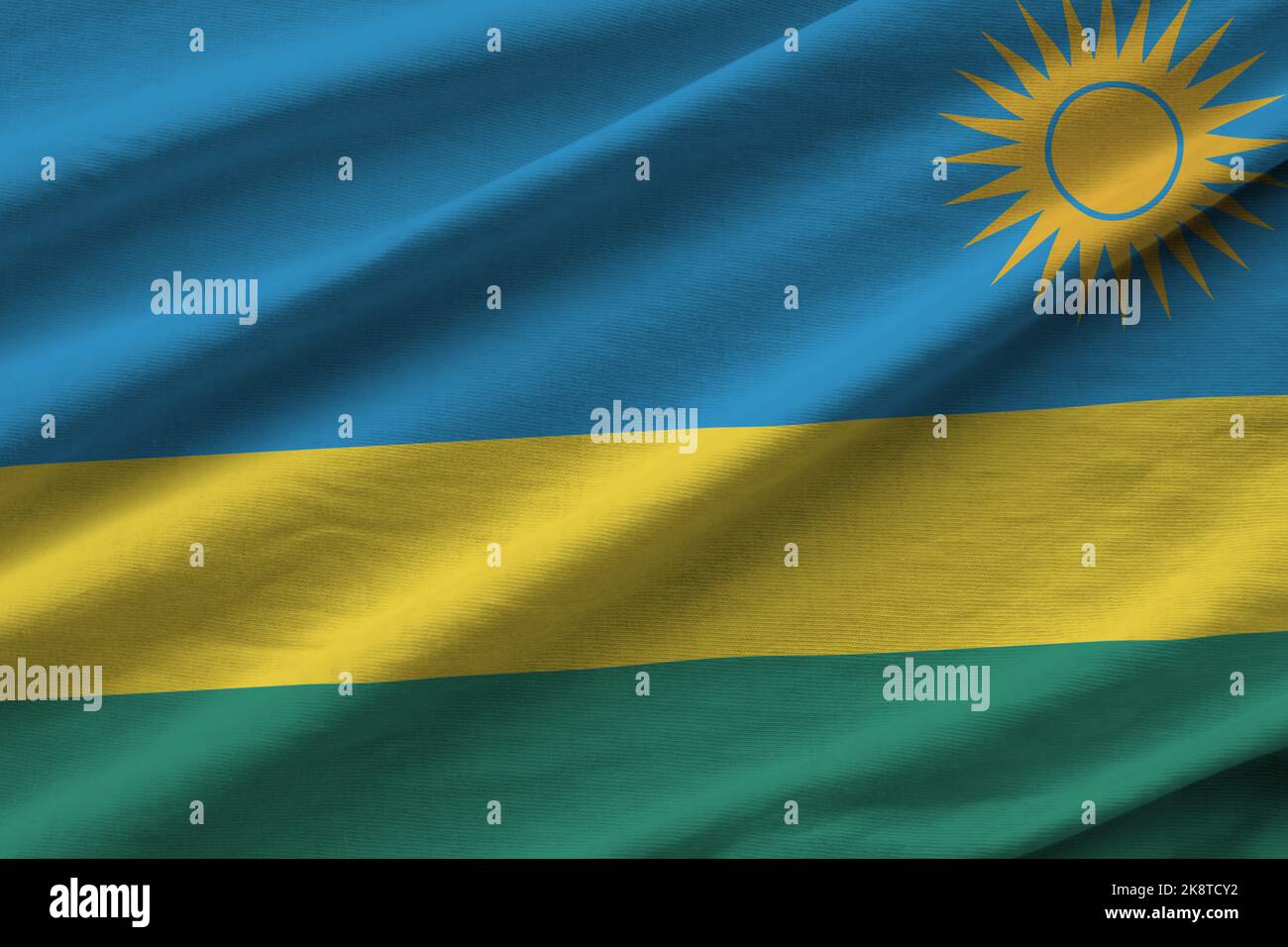 Rwanda flag with big folds waving close up under the studio light ...