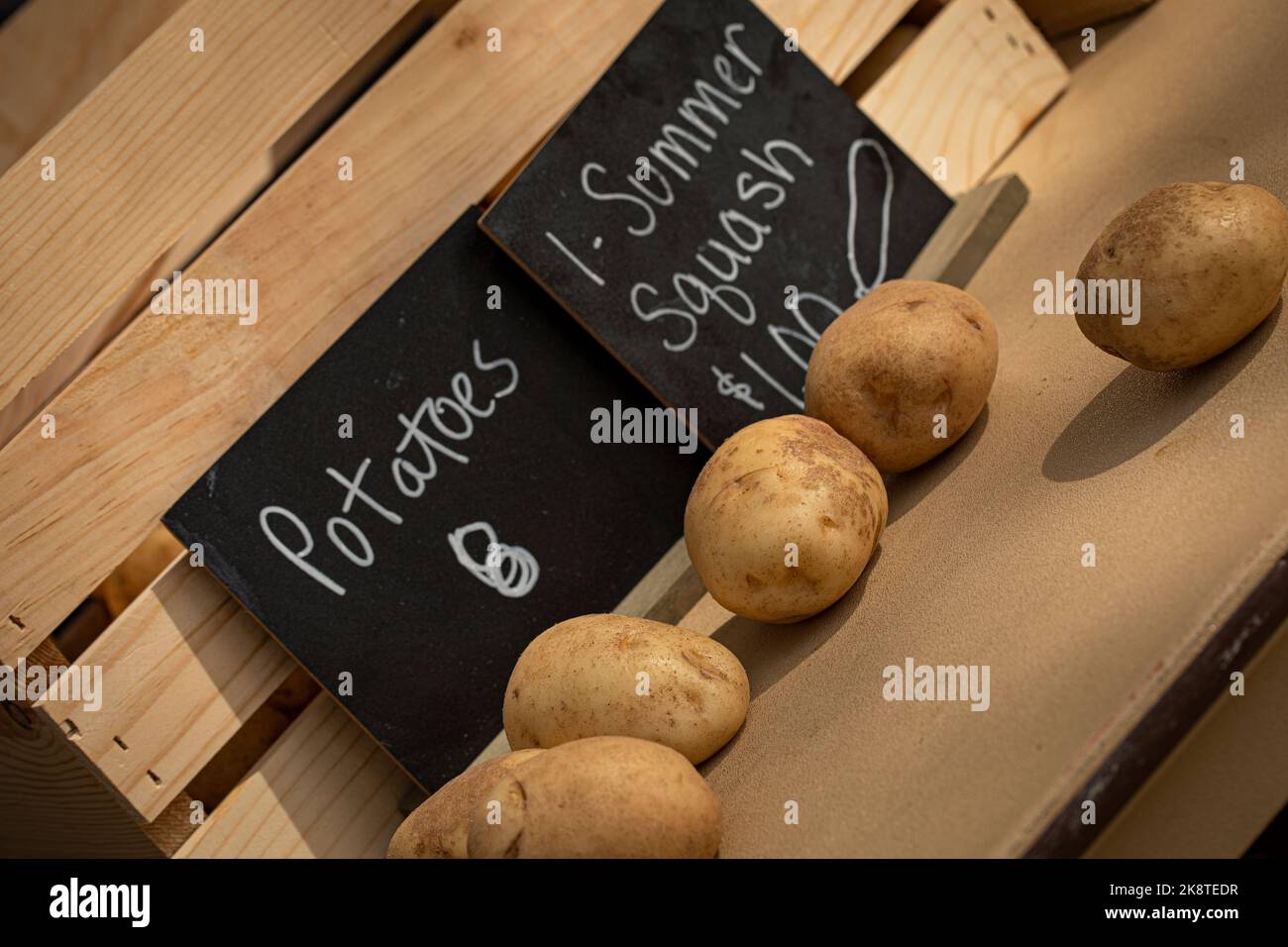A closeup shot of freshly harvested potatoes sold on market with black ...