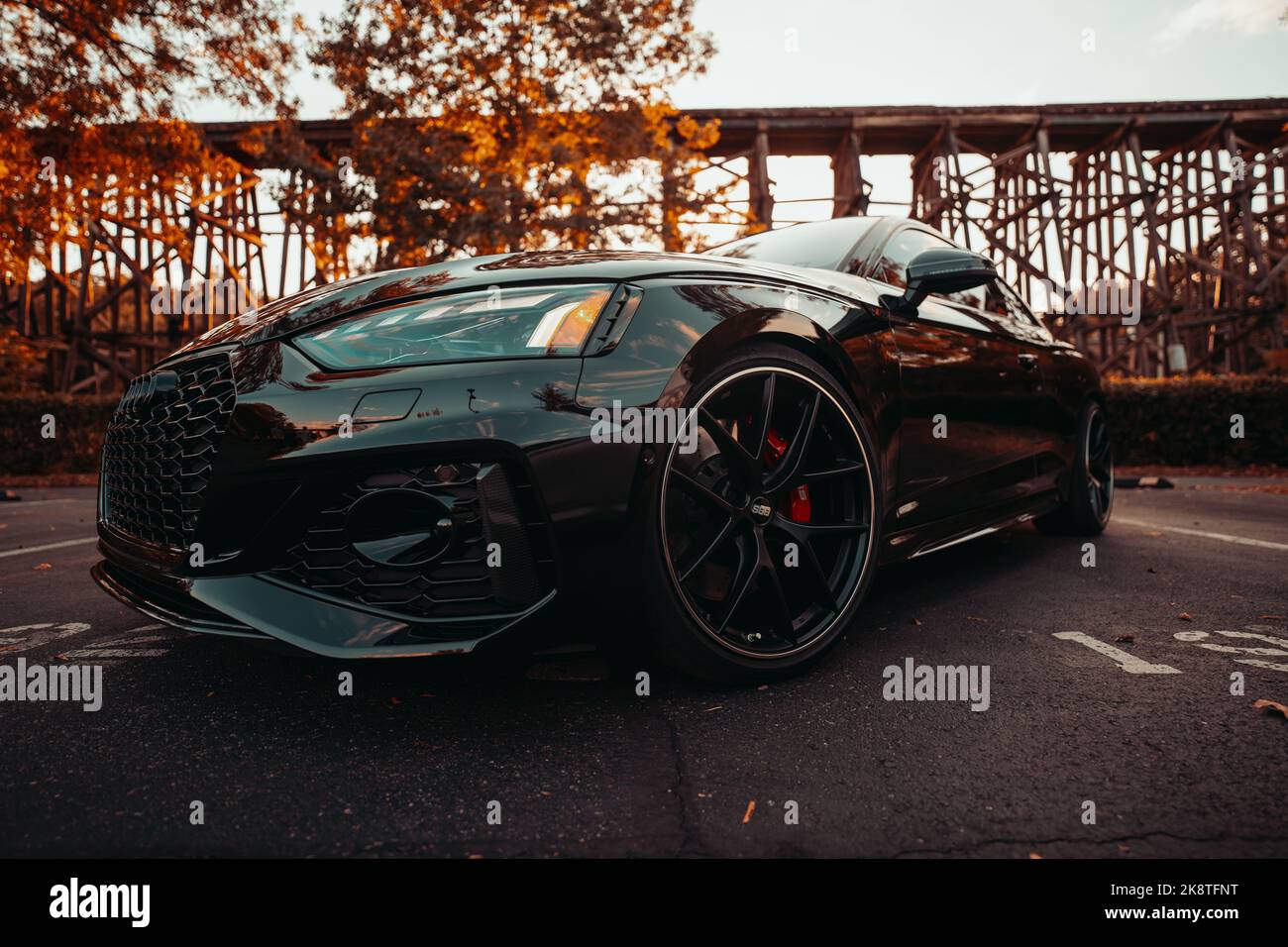 Front view of a modern black Audi RS5 on the street during an autumn ...