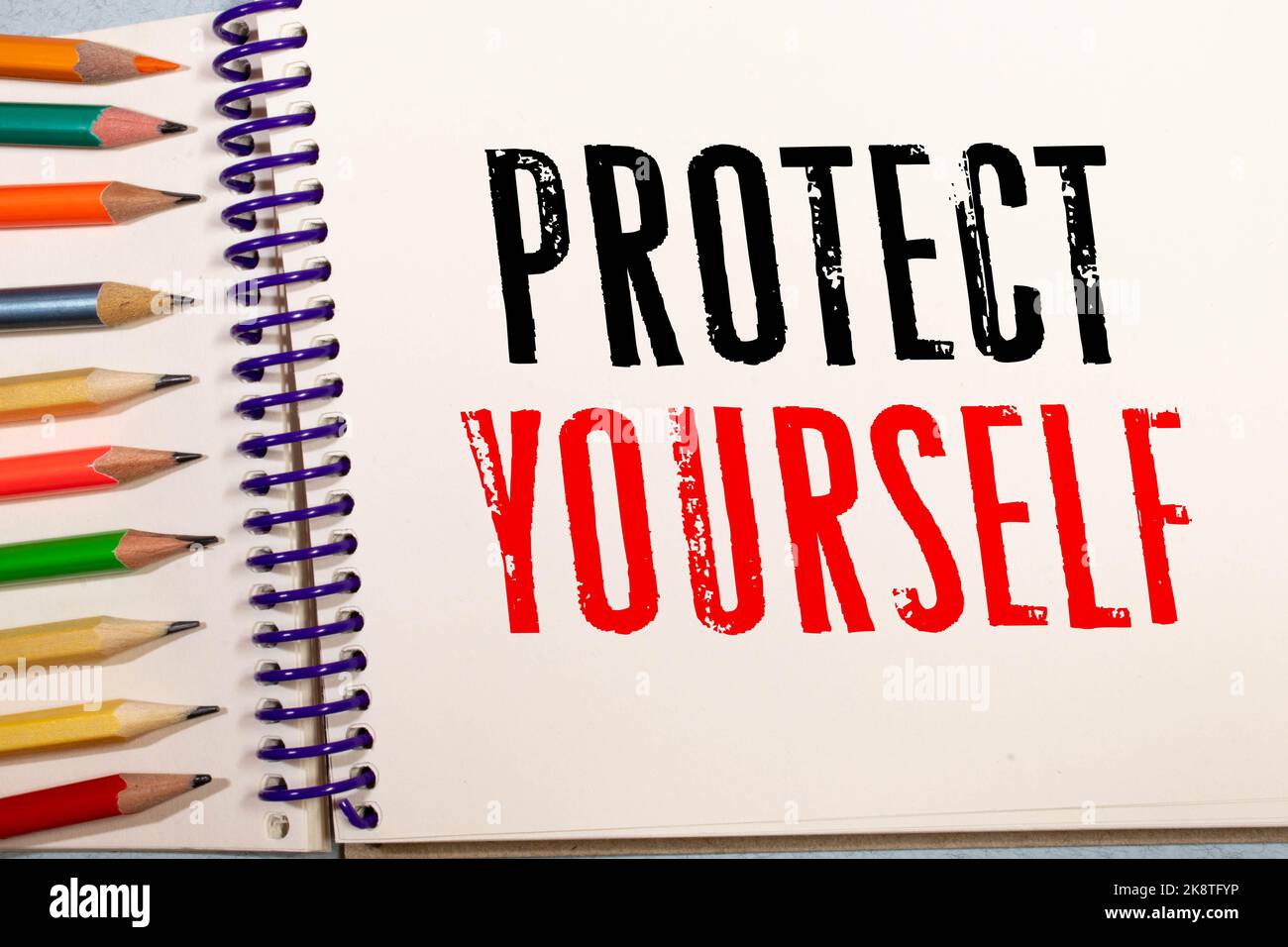 PROTECT YOURSELF text on the piece of paper on the red wood background ...