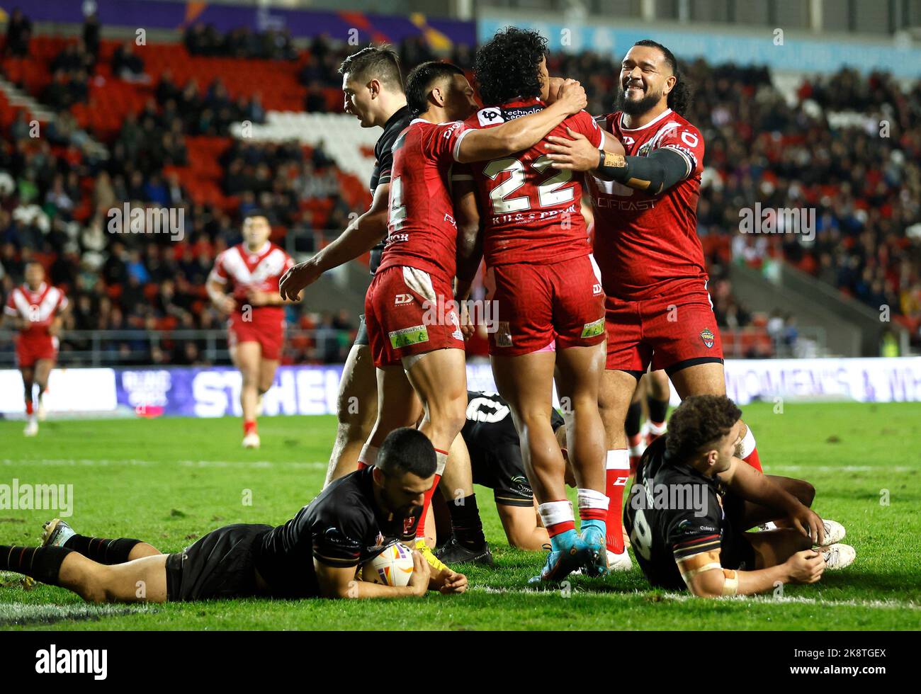 Tonga's Tesi Niu (centre) celebrates scoring his side's fourth try of ...