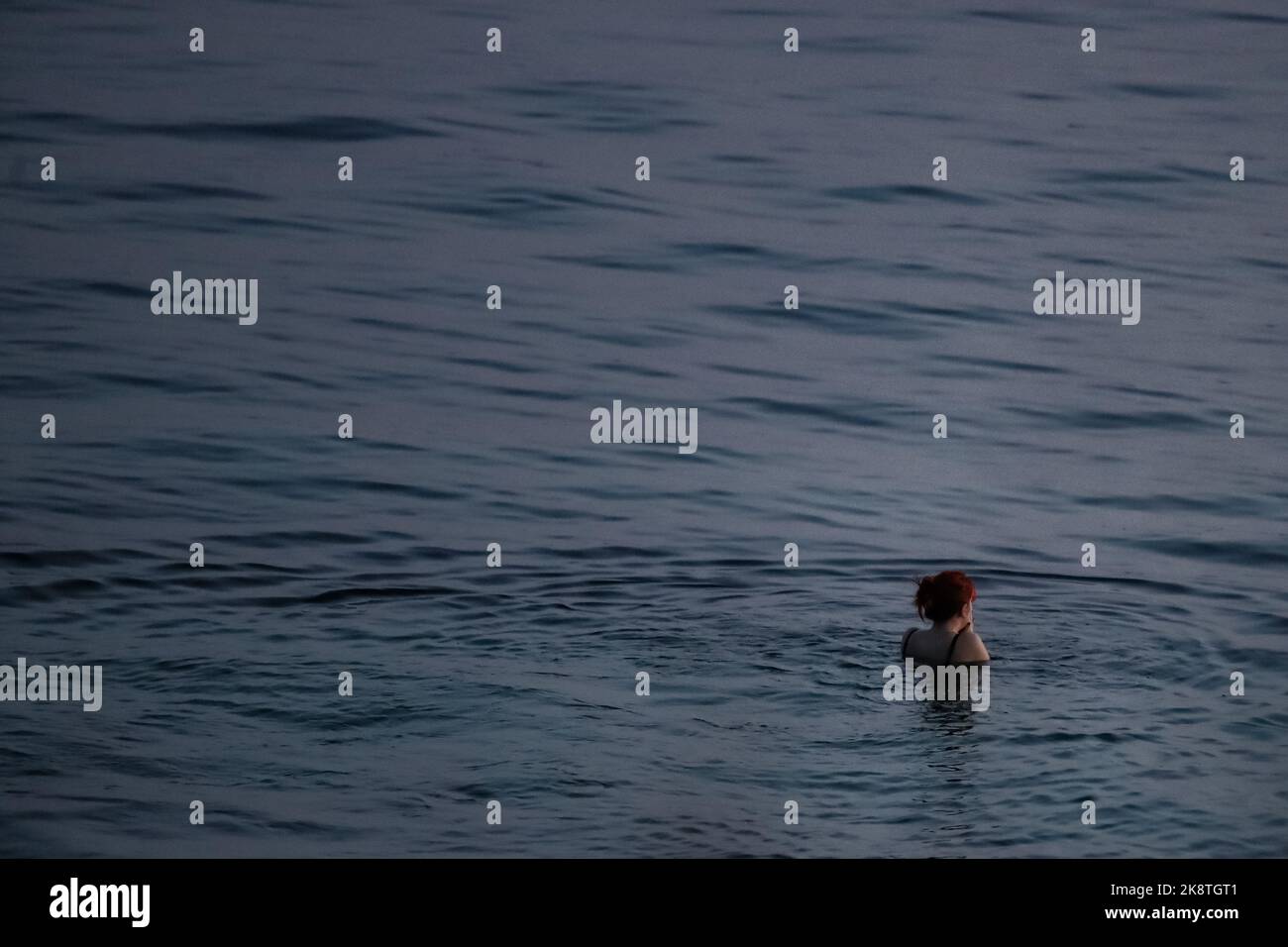 Brave swimmers are seen enjoying an autumn evening swim in the sea, in ...