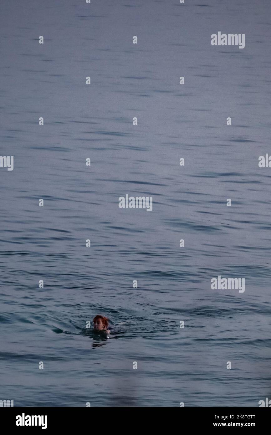 Brave swimmers are seen enjoying an autumn evening swim in the sea, in ...