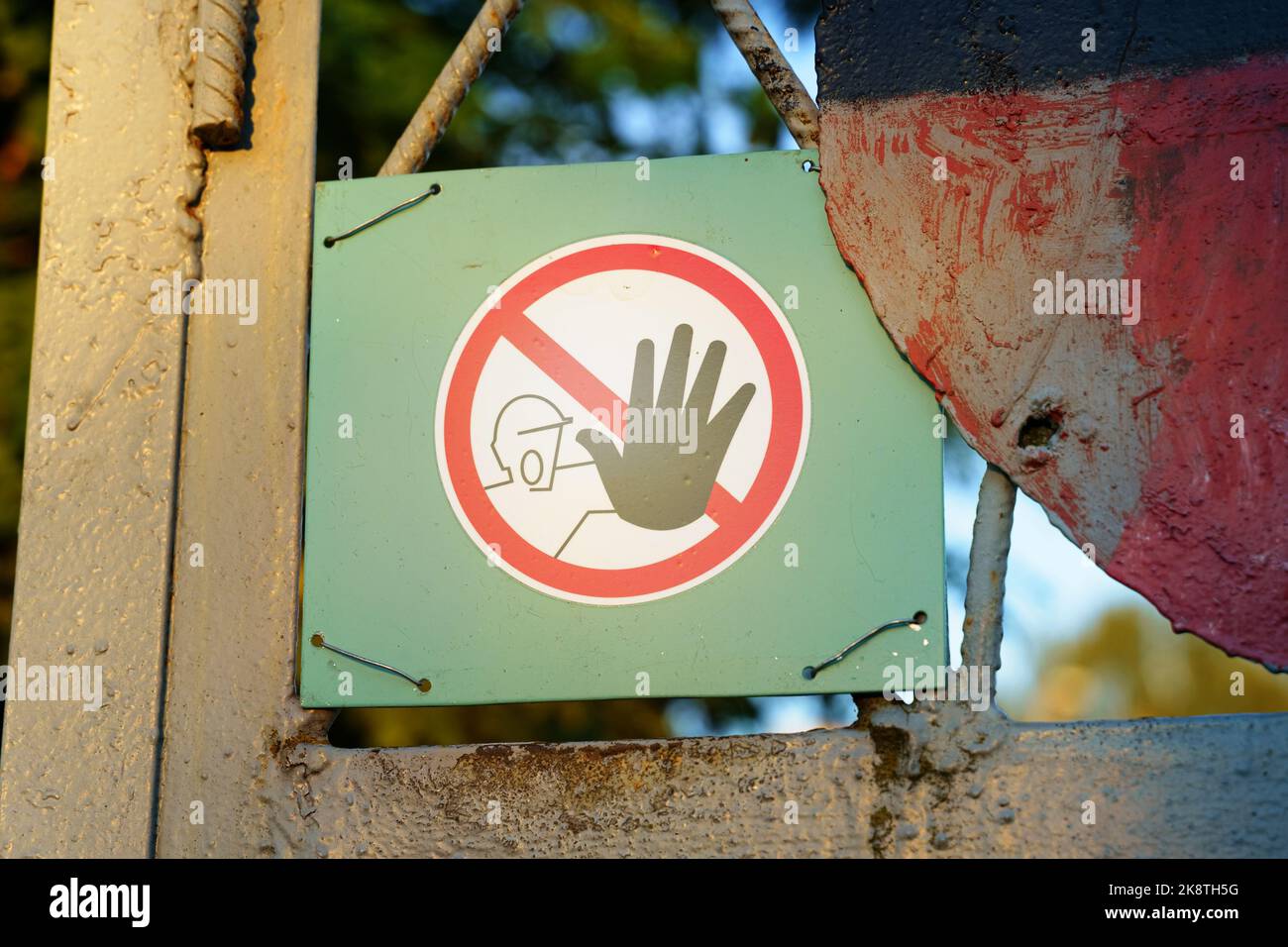 A warning sign hangs on the fence - entry into the restricted area is ...