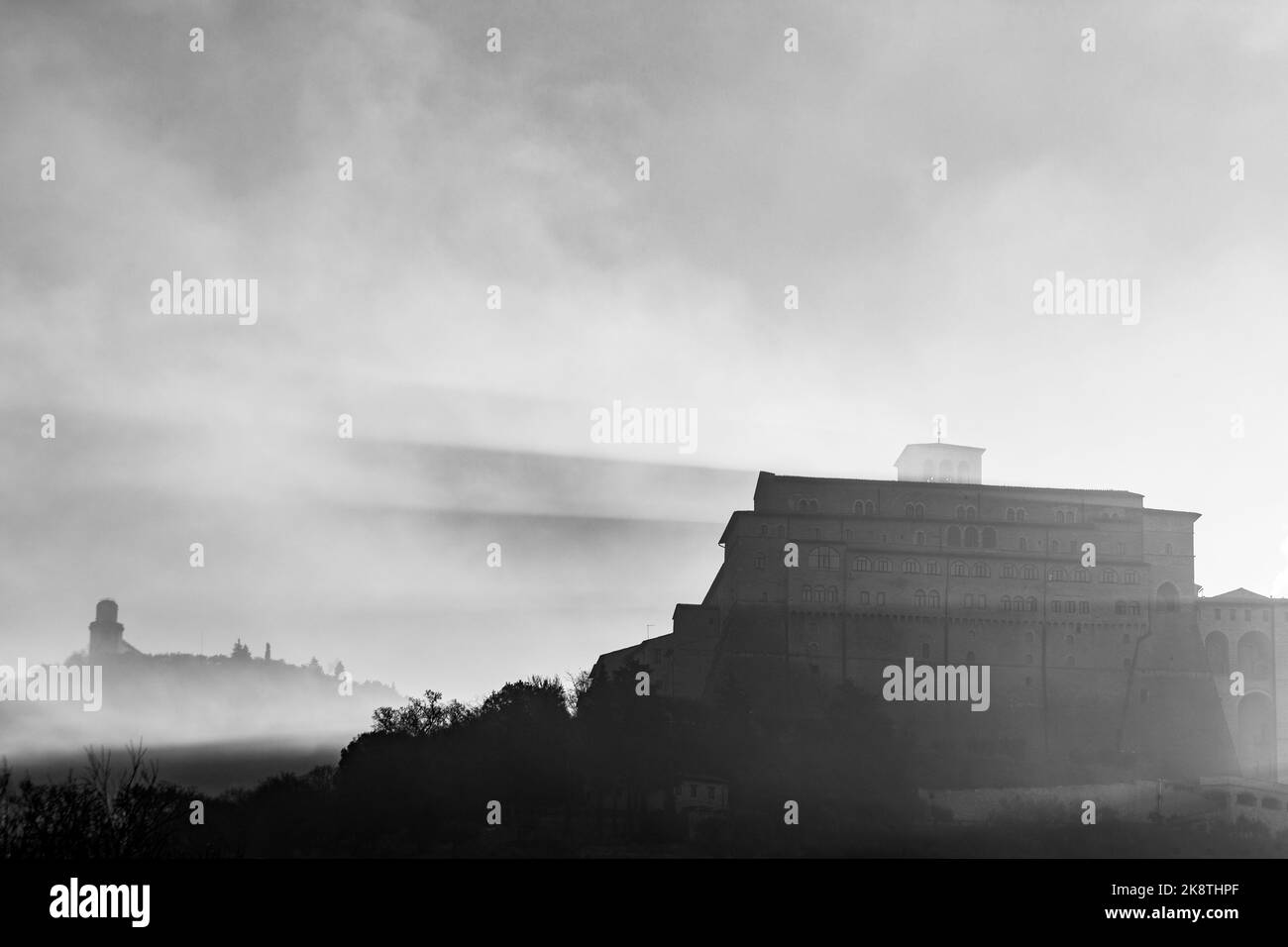A view of a silhouette of St.Francis church in Assisi in the mist, with ...