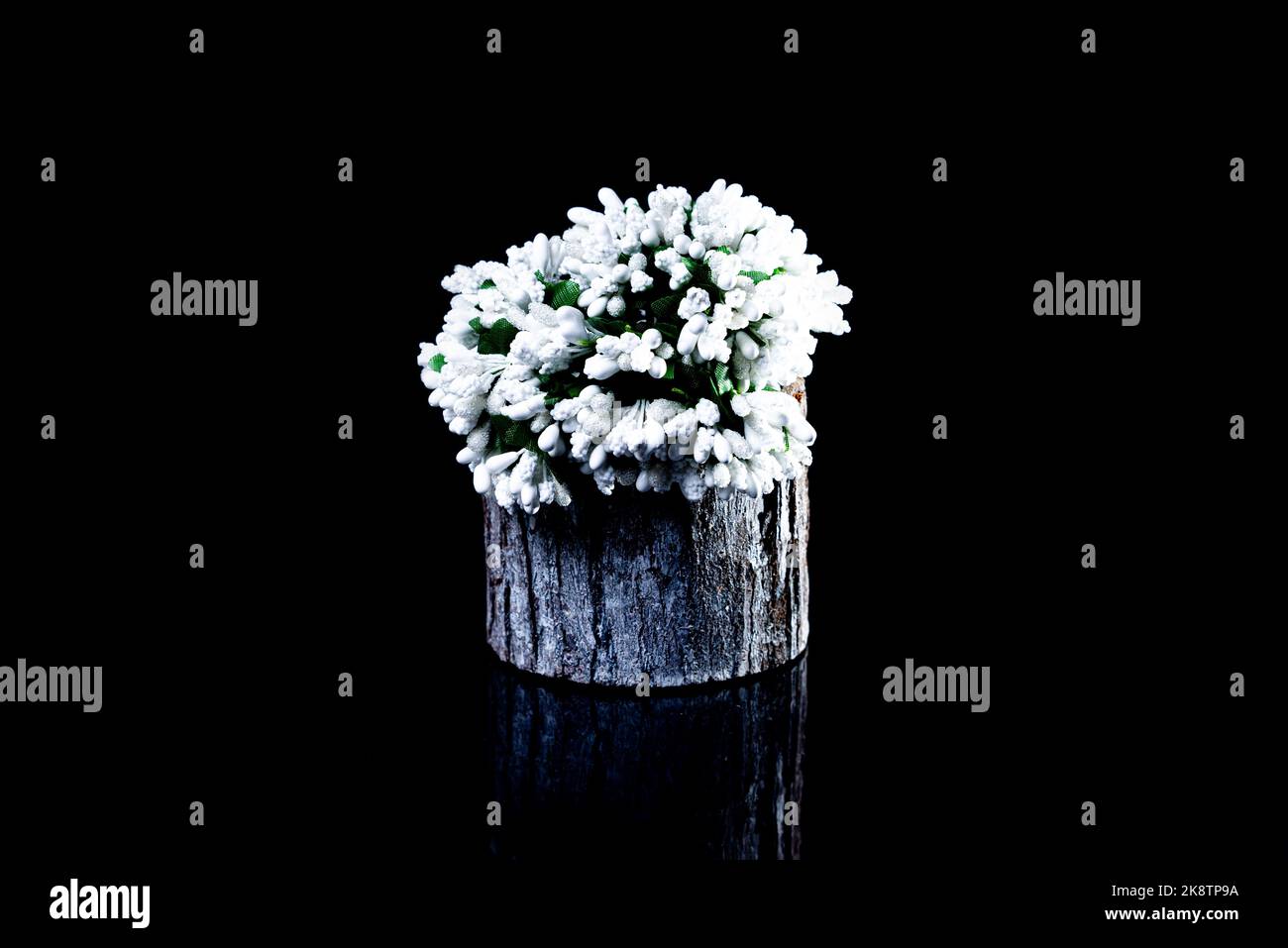 A close up shot of wooden vase with white flowers . The porcelain vase ...