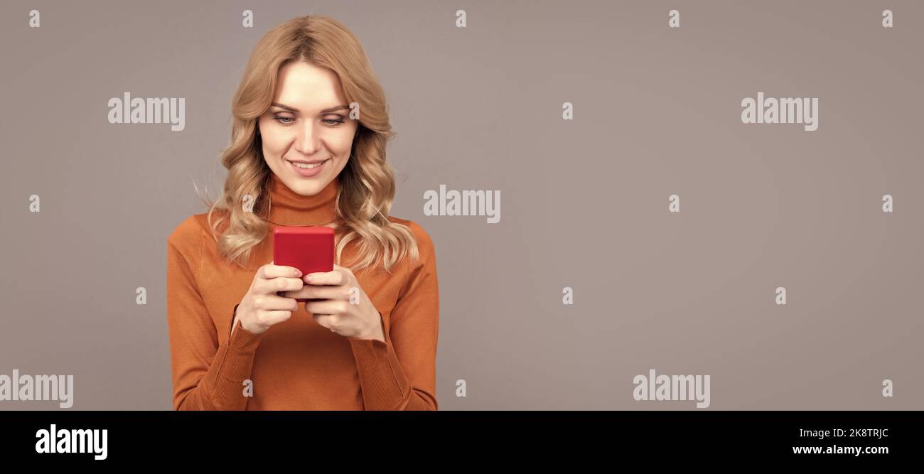 Pretty woman text short message on mobile phone device grey background ...