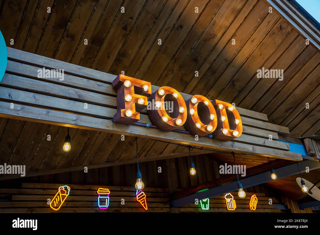 the glowing street sign of the FOOD street cafe Stock Photo - Alamy