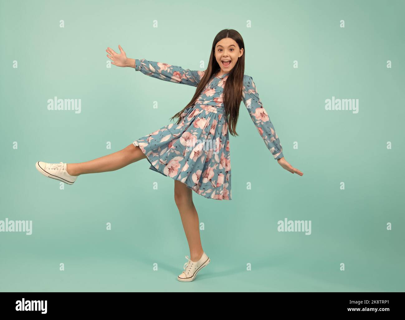Happiness, freedom, motion and child. Young teenager girl jumping over ...