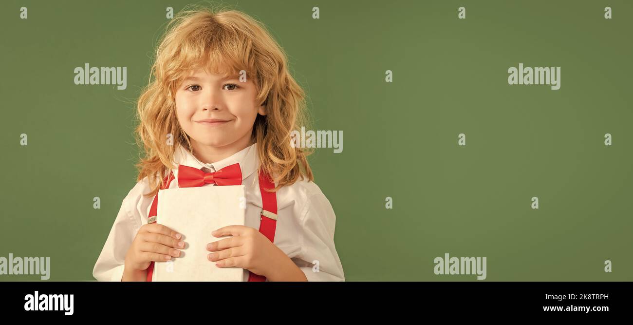 School pupil boy on blackboard, banner copy space. smiling kid boy in ...