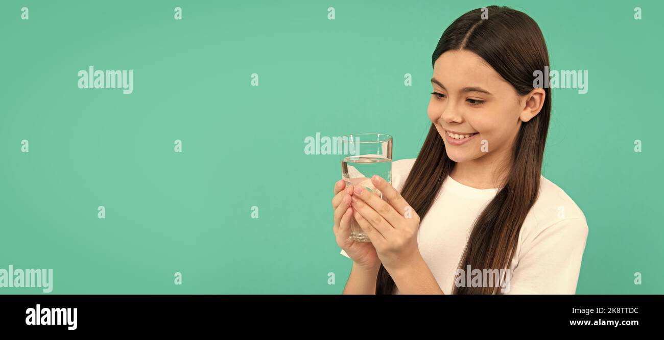 happy kid going to drink glass of water to stay hydrated and keep daily ...