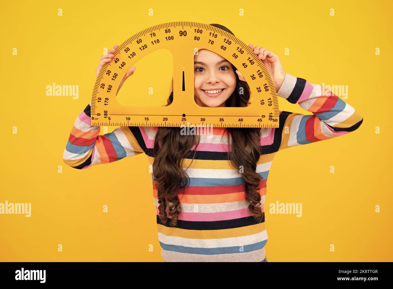 Measuring school equipment. Schoolgirl holding measure for geometry ...