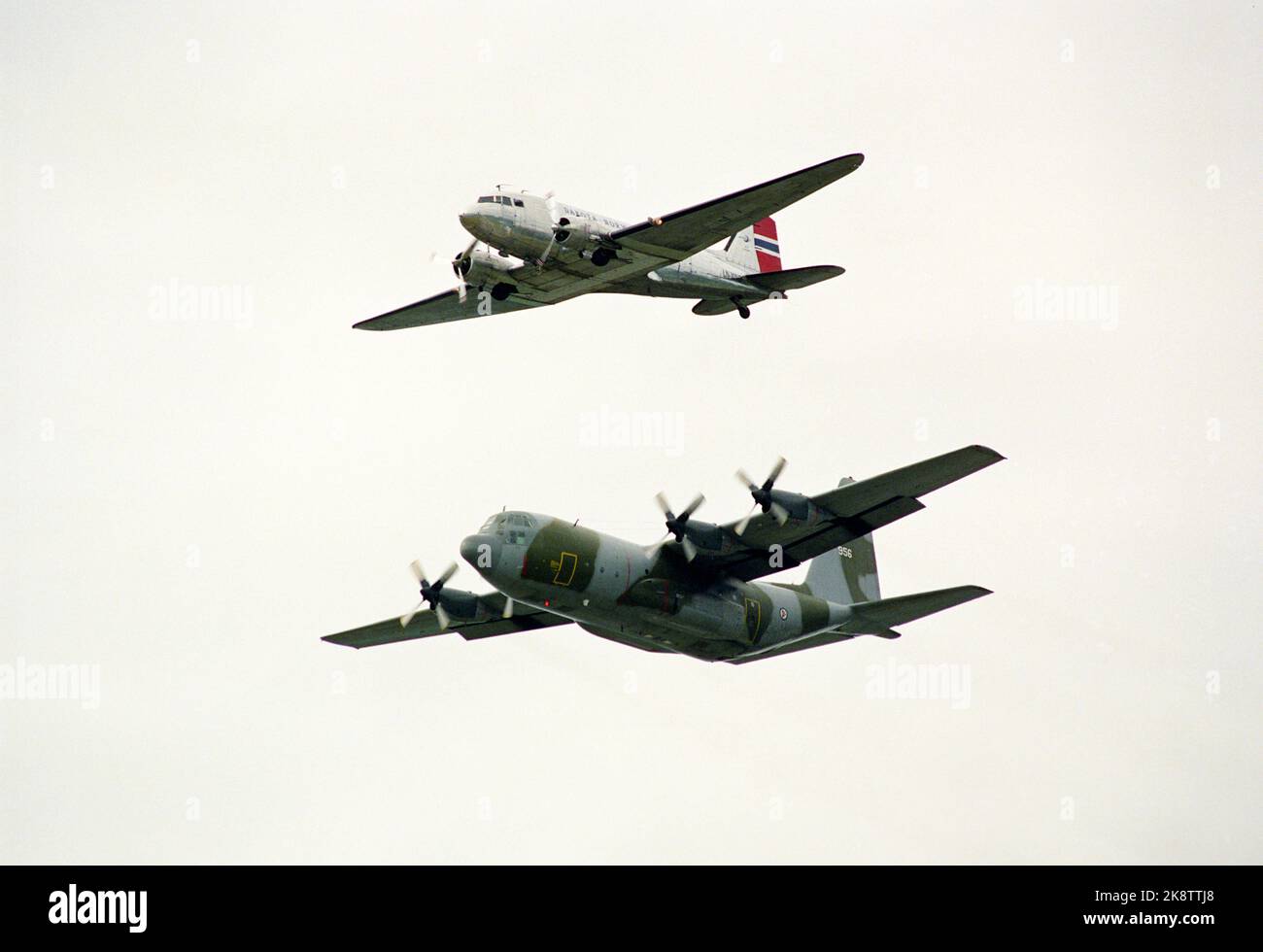 Hercules transport aircraft below in formation with falcon jet photo hi ...