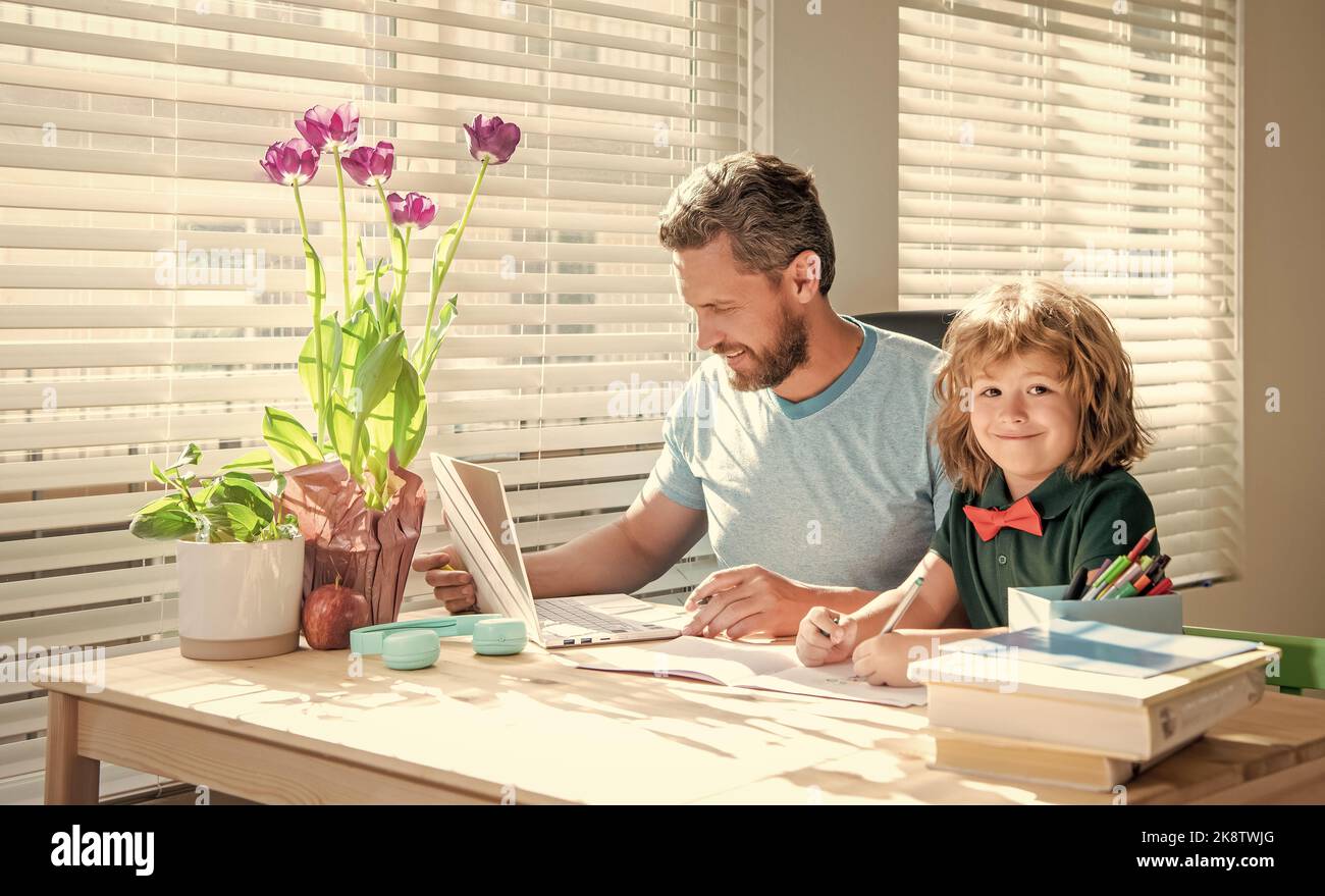bearded dad writing school homework with his child son in classroom ...