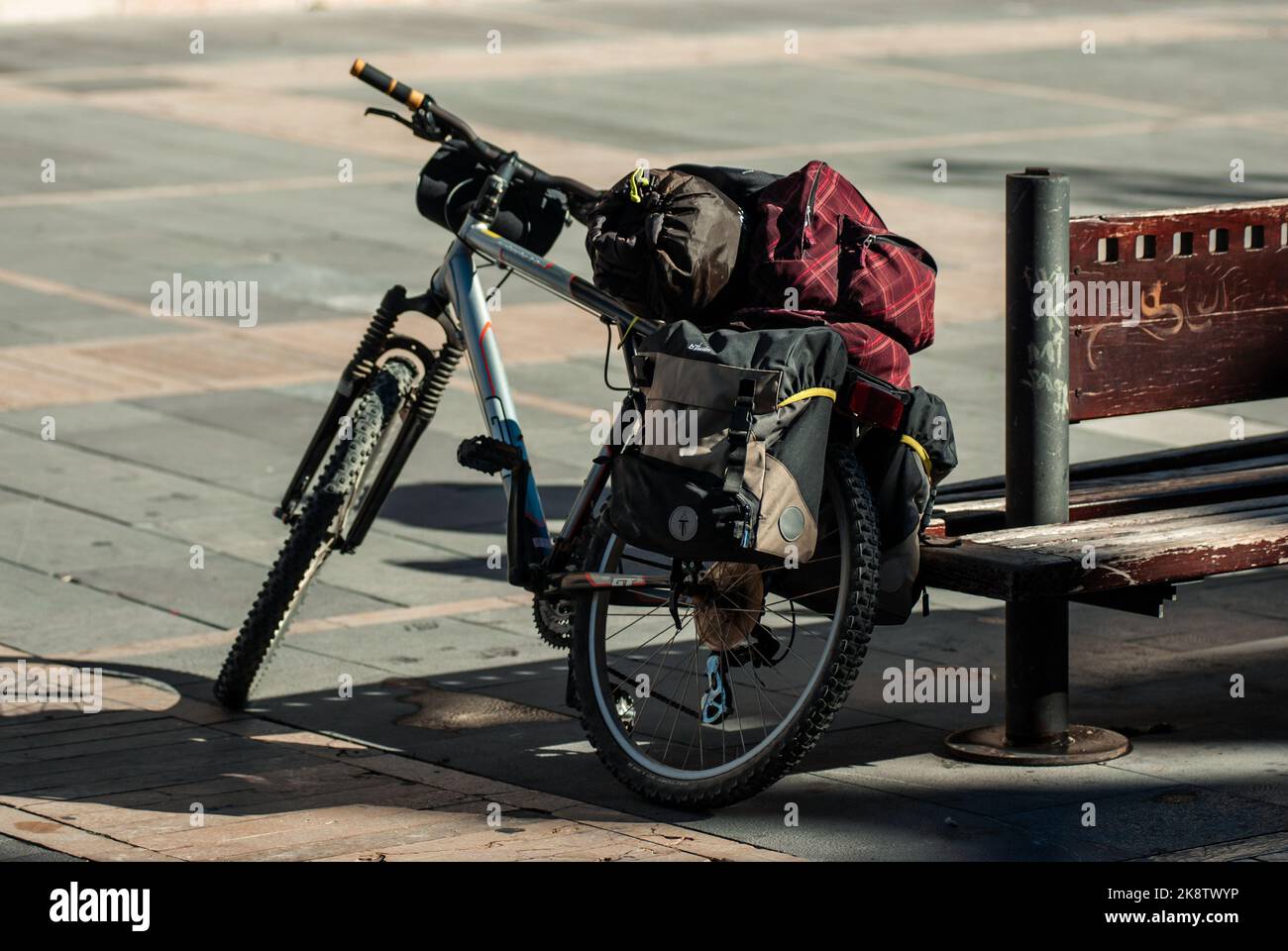 Bicycle with pilgrim luggage leaning on bench in Leon Stock Photo - Alamy
