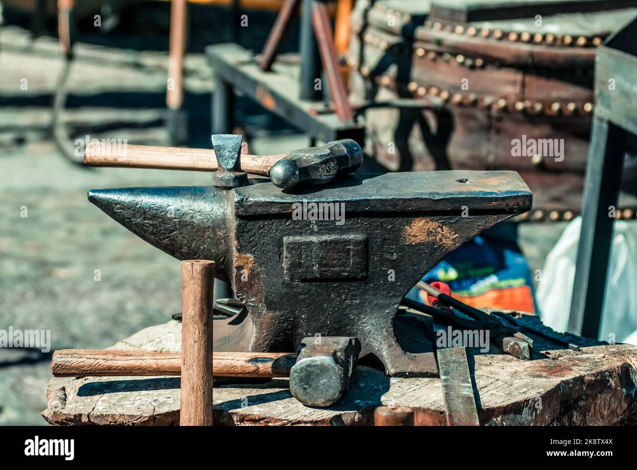 Blacksmith's hammer on a metal anvil in the forge with tools Stock ...
