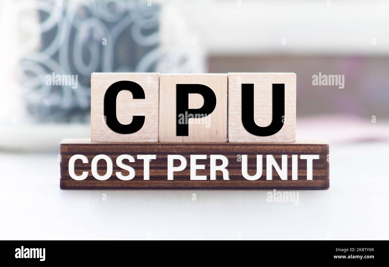 Closeup on businessman holding a card with text CPU COST PER UNIT ...